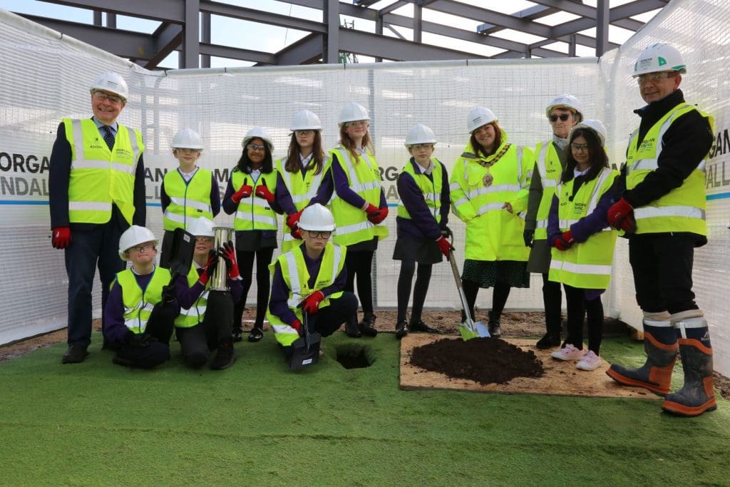 Children bury a time capsule on the new King Henry VIII school in ...